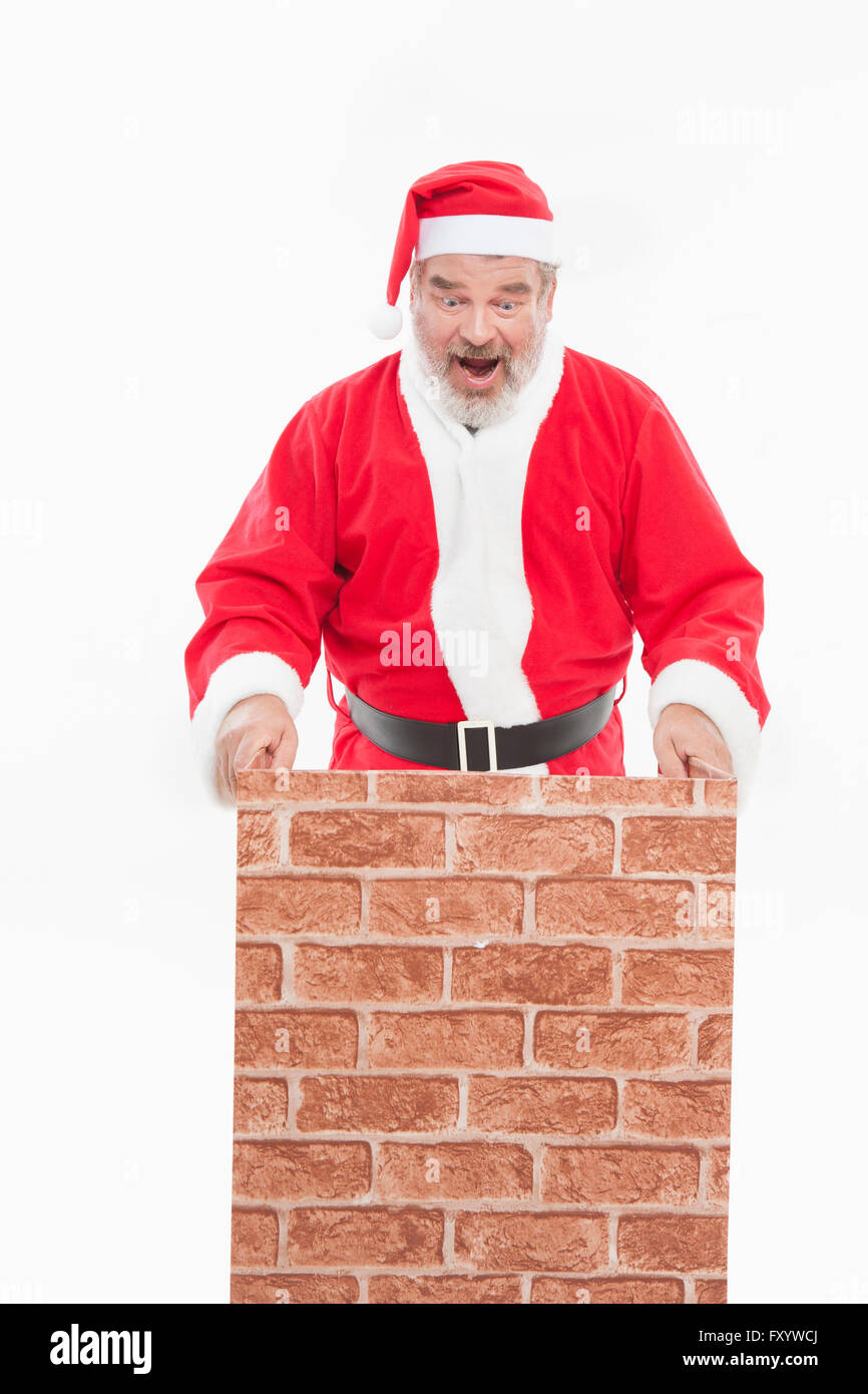Portrait of Santa looking down with a surprised face in a chimney Stock ...