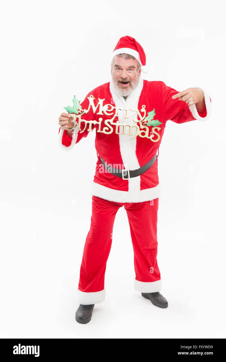 Smiling Santa standing with message of Merry Christmas and pointing to ...
