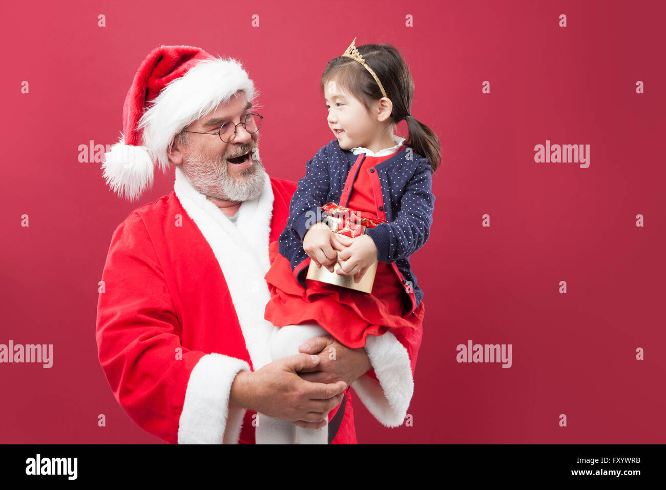 Santa holding present hi-res stock photography and images - Alamy