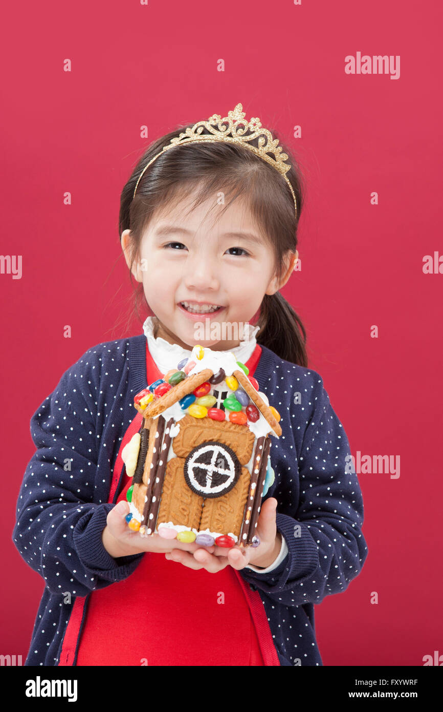 Portrait of smiling girl holding a present staring at front Stock Photo ...