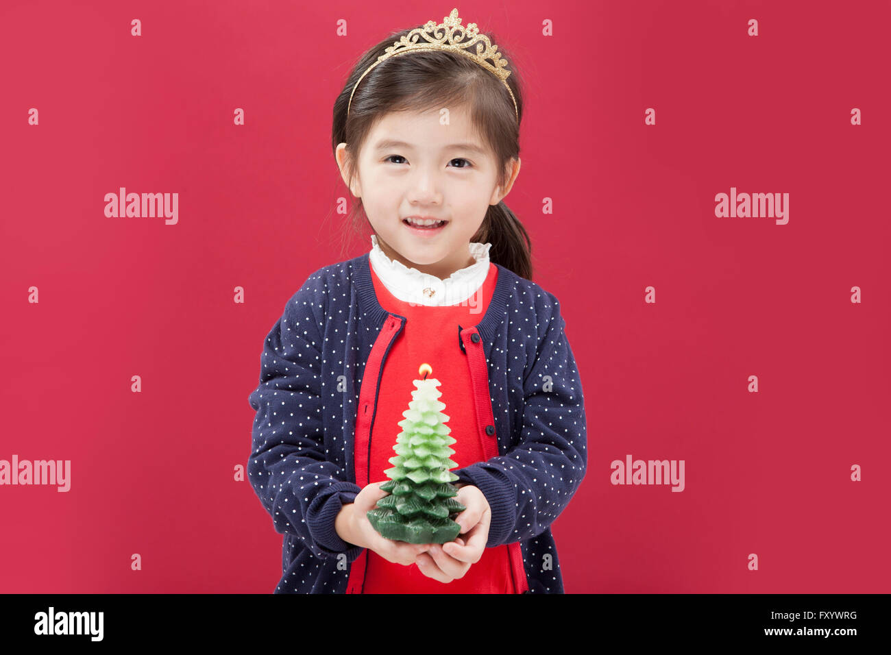 Portrait of smiling girl holding a tree staring at front Stock Photo ...