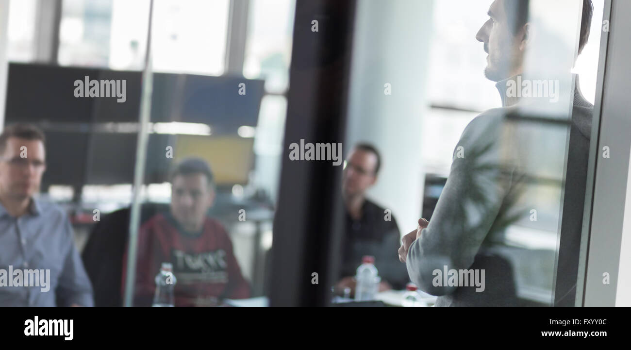 Business team leader delivering presentation in office Stock Photo - Alamy
