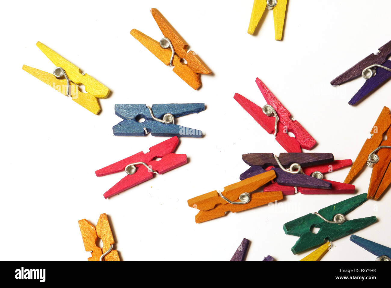 Mini colourful pegs on white background Stock Photo - Alamy