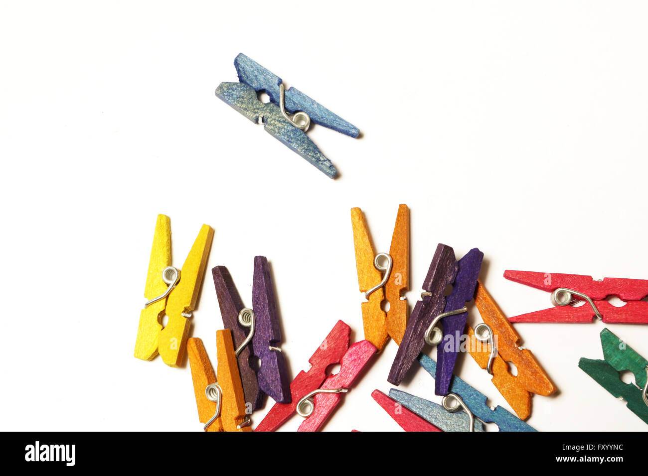 Mini colourful pegs on white background Stock Photo - Alamy