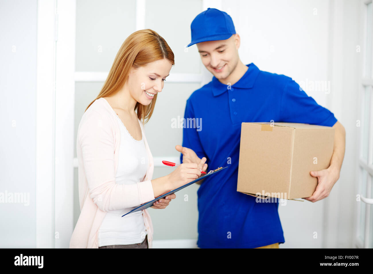 Signing for parcel receive Stock Photo - Alamy