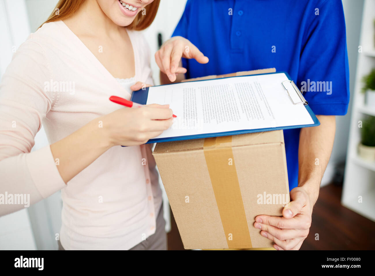 Signing for delivery Stock Photo - Alamy