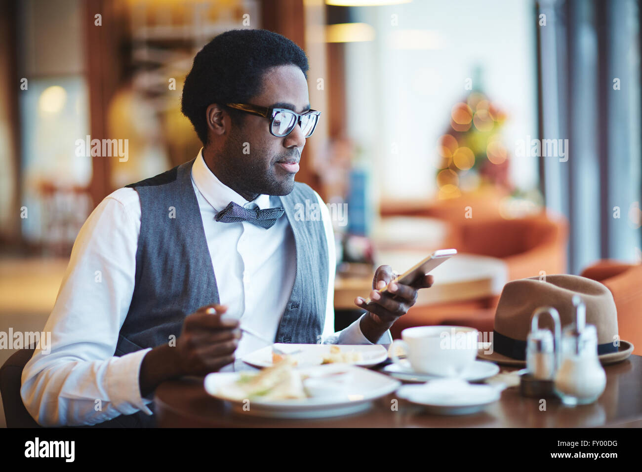 Young man in cafe Stock Photo - Alamy