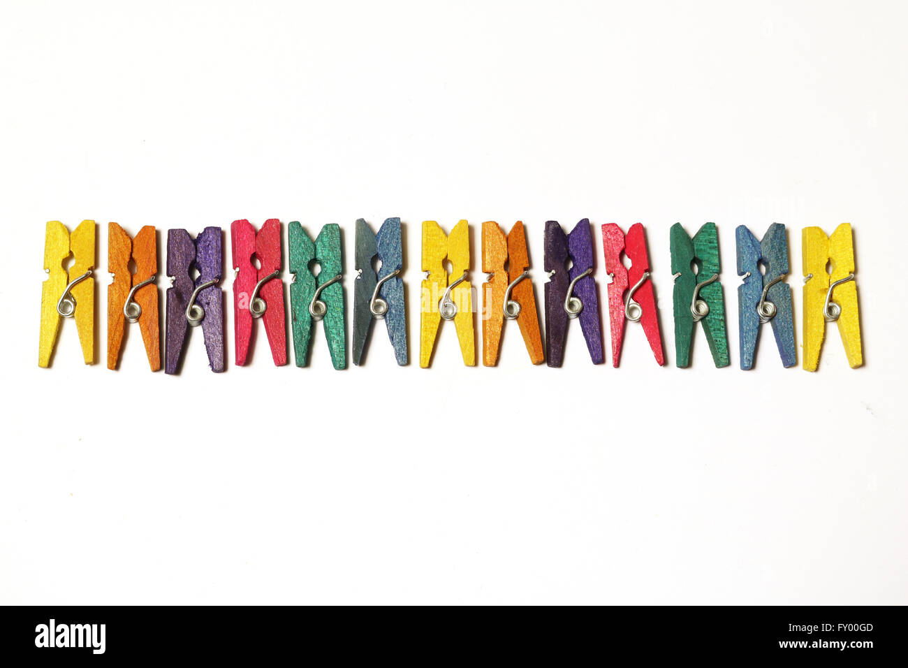 Mini colourful pegs on white background Stock Photo - Alamy