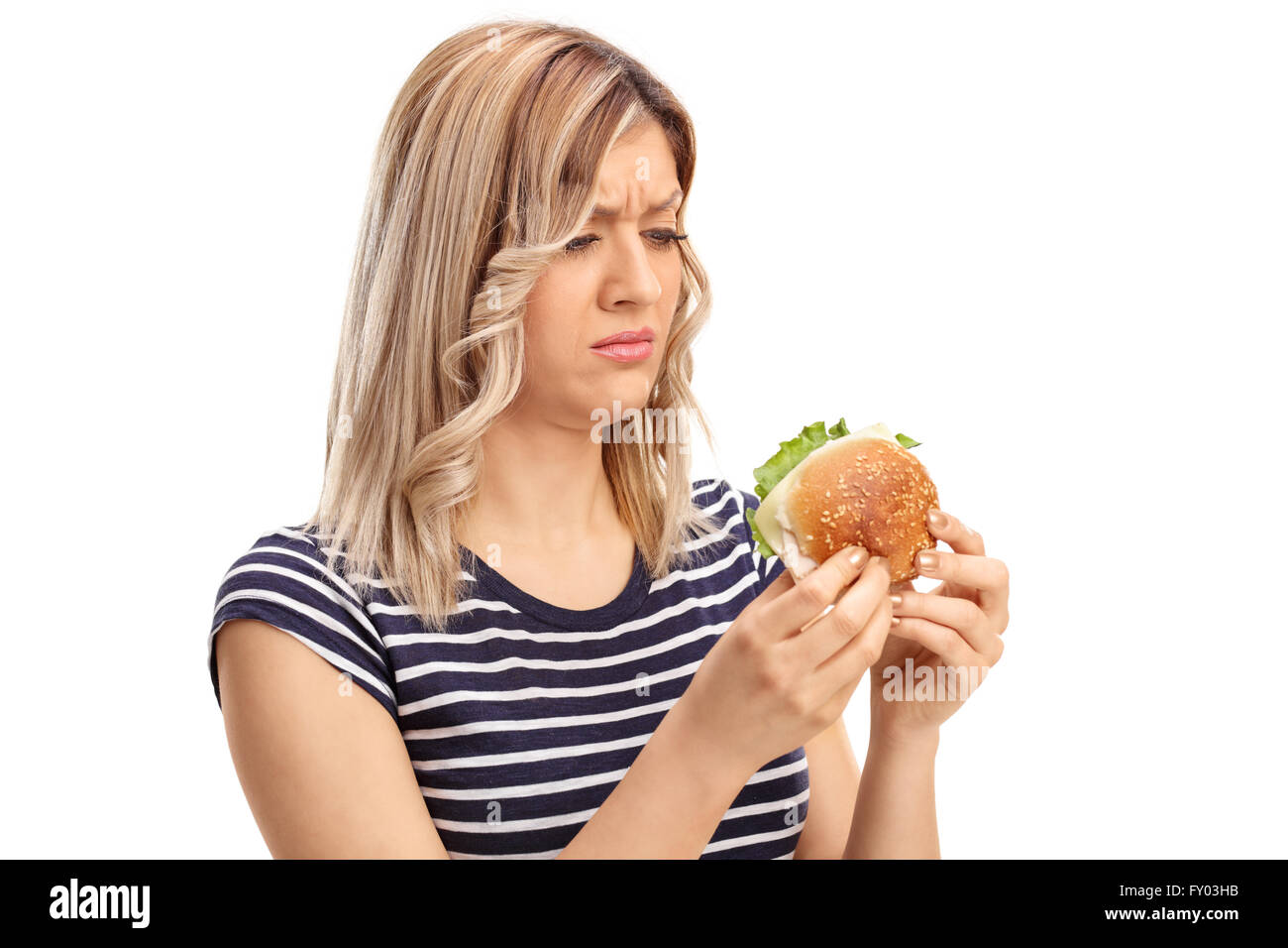 Sad woman holding a tasty looking sandwich and thinking isolated on ...
