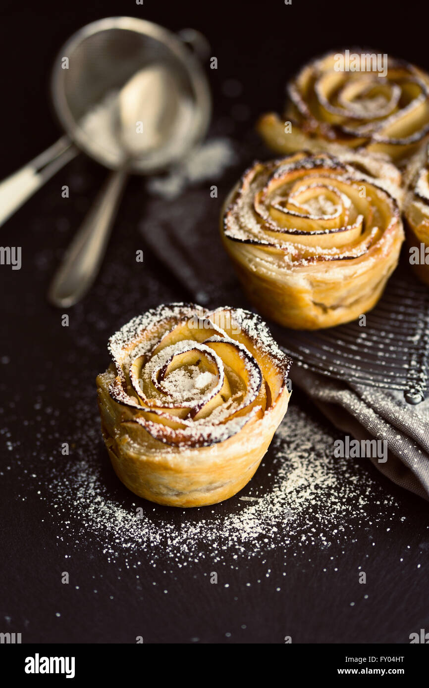 mini apple roses puff pastry with icing sugar Stock Photo - Alamy