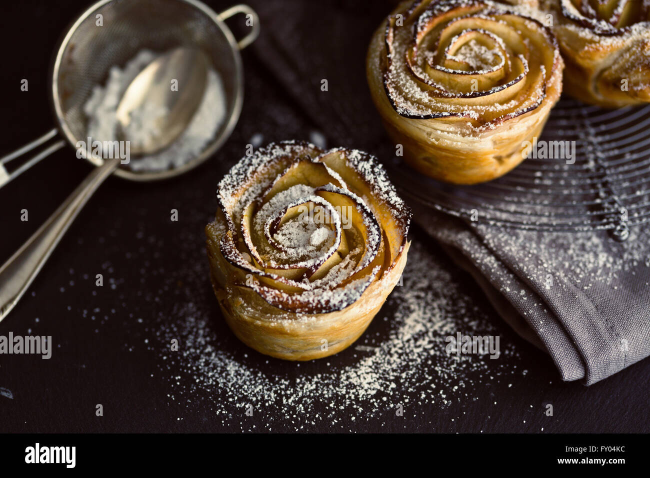 mini apple roses puff pastry with icing sugar Stock Photo - Alamy