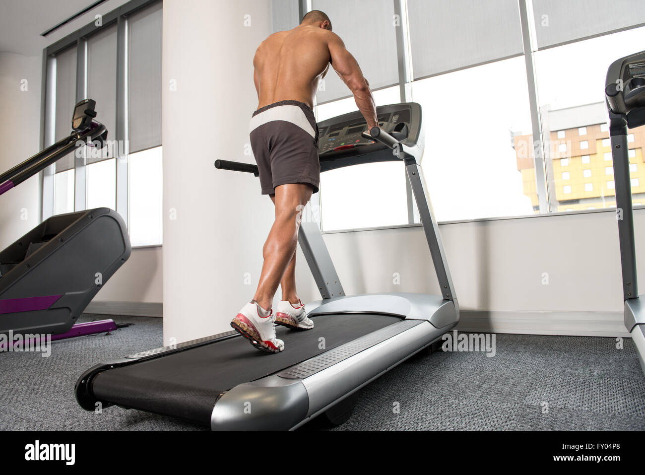 Handsome Man Running On The Treadmill In Gym Stock Photo - Alamy