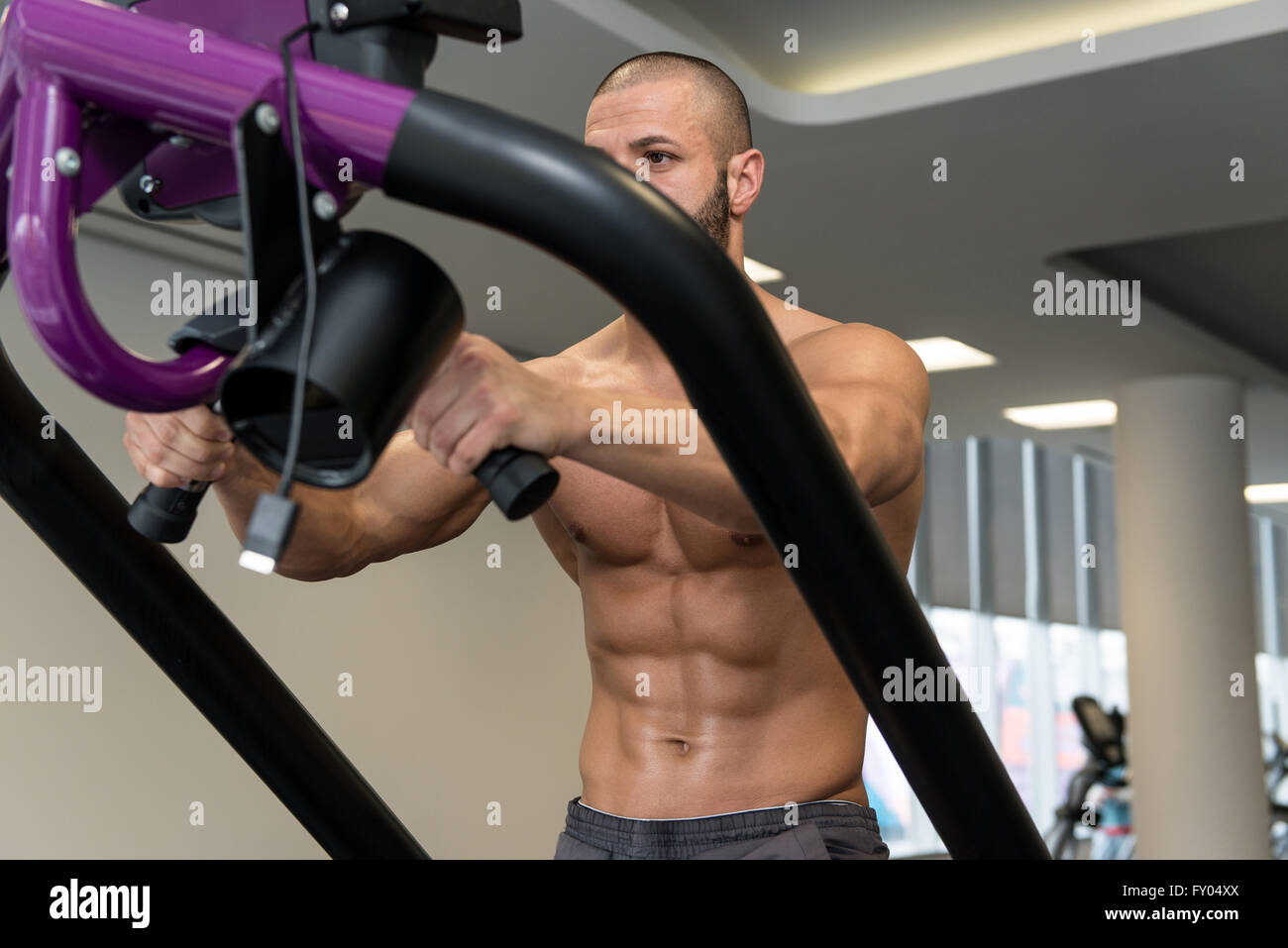 Handsome Man Exercising On A Stepper In Gym Stock Photo - Alamy