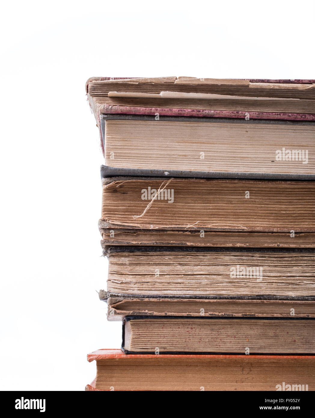 Well worn pile or stack of yellowed books with covers and pages looking ...