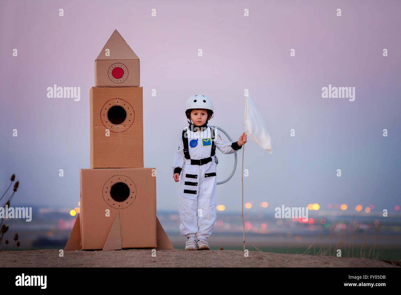 Adorable little boy, dressed as astronaut, playing in the park with ...