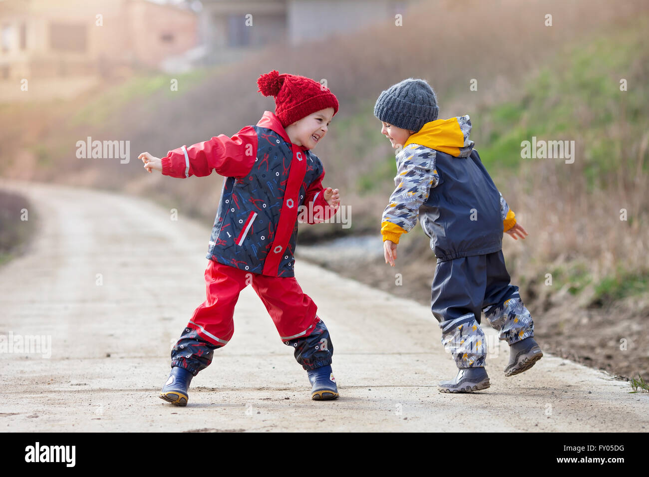 Two cute children, boy brothers, playing together in the park, rural ...