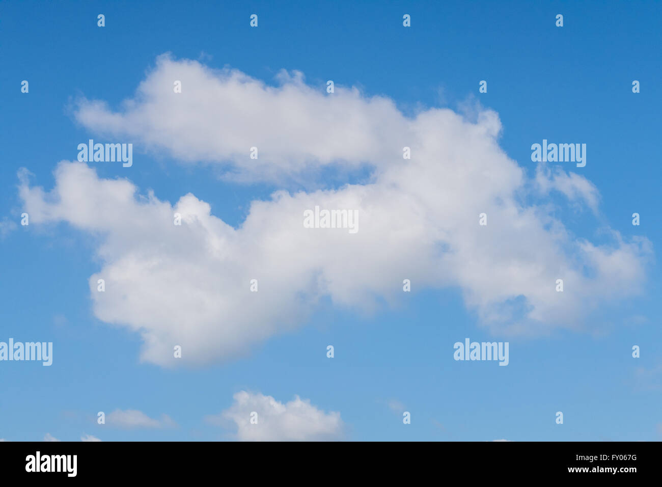 The concept of tranquility with white fluffy clouds against a blue sky ...