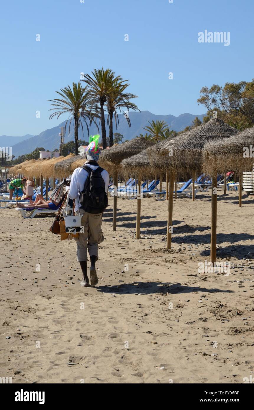 Man selling bags by the beach in Marbella, Spain Stock Photo - Alamy