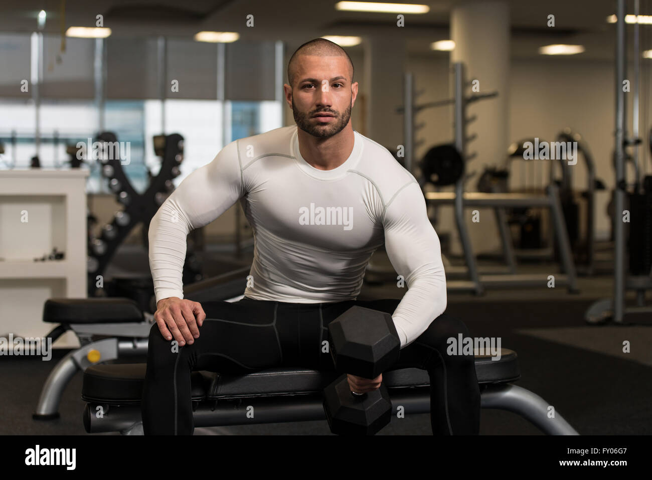 Young Healthy Man Working Out Biceps - Dumbbell Concentration Curls ...
