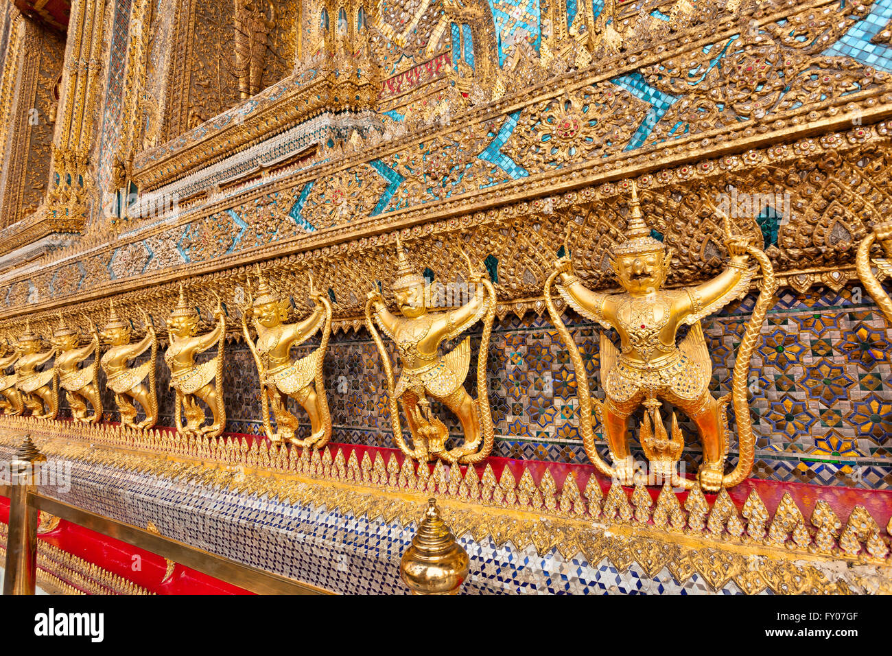 Golden wall decor at the Grand Palace in Bangkok, Thailand Stock Photo ...