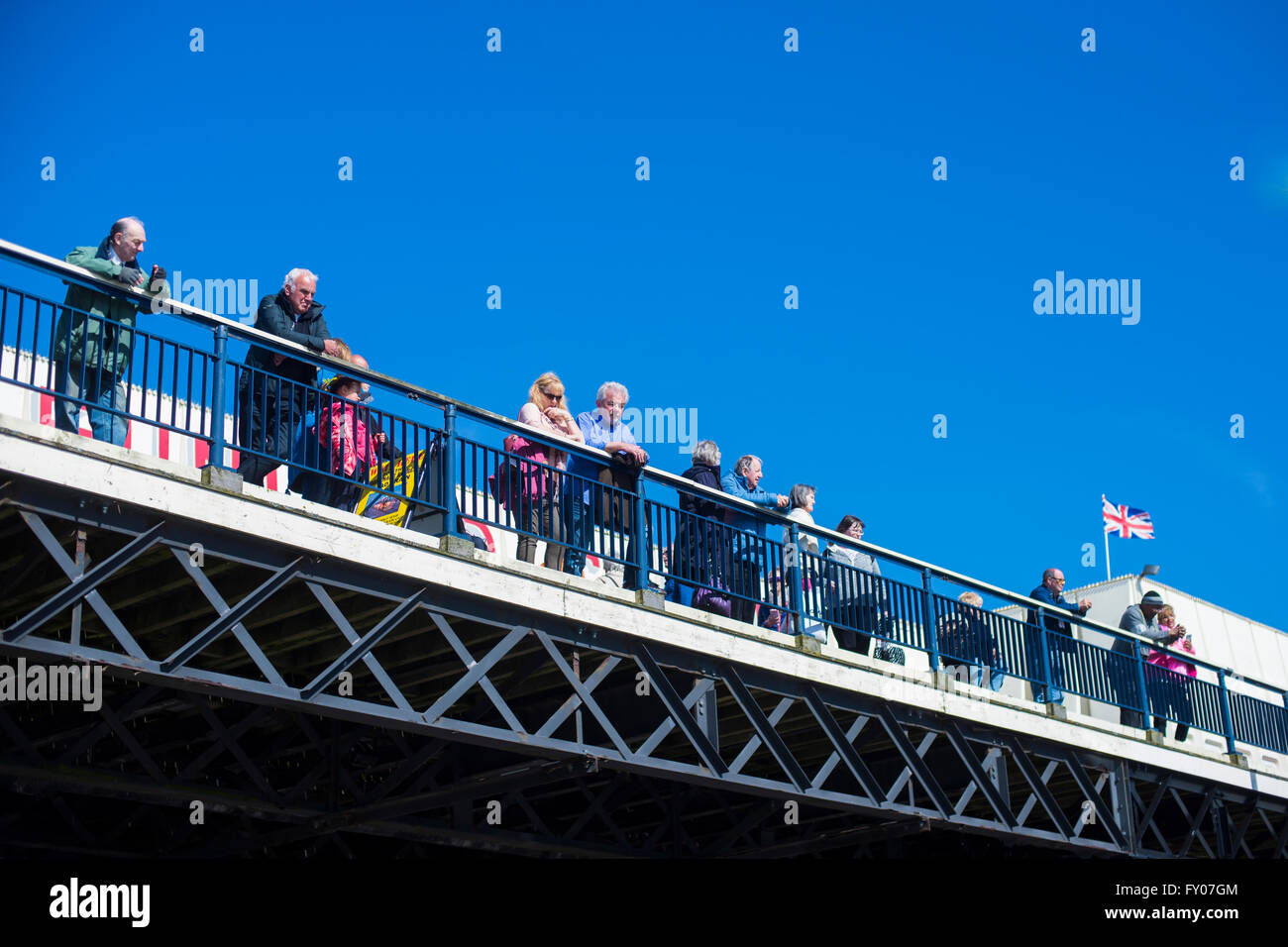 british people looking over a bridge with union jack flag in background ...