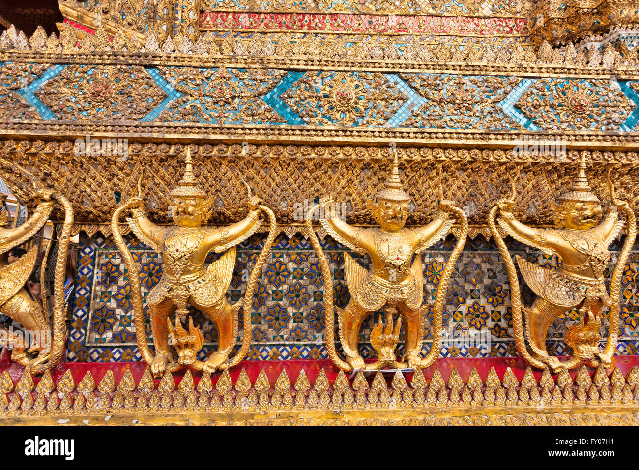 Golden wall decor at the Grand Palace in Bangkok, Thailand Stock Photo ...