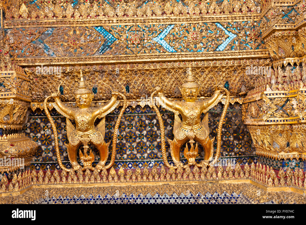 Golden wall decor at the Grand Palace in Bangkok, Thailand Stock Photo ...
