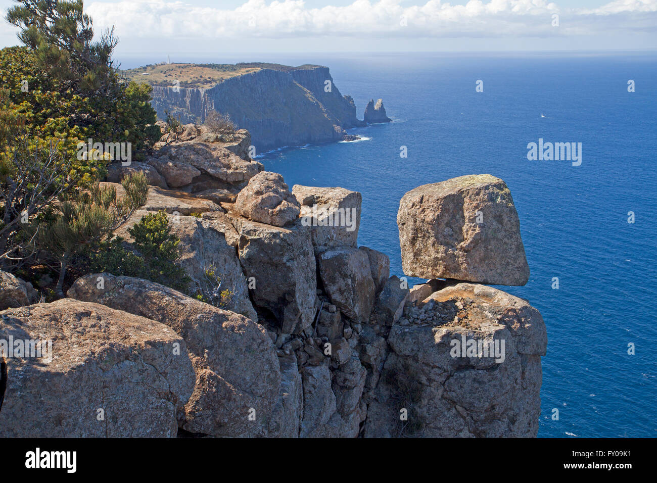 Boulder balanced on cliffs near Cape Pillar, with Tasman Island behind ...