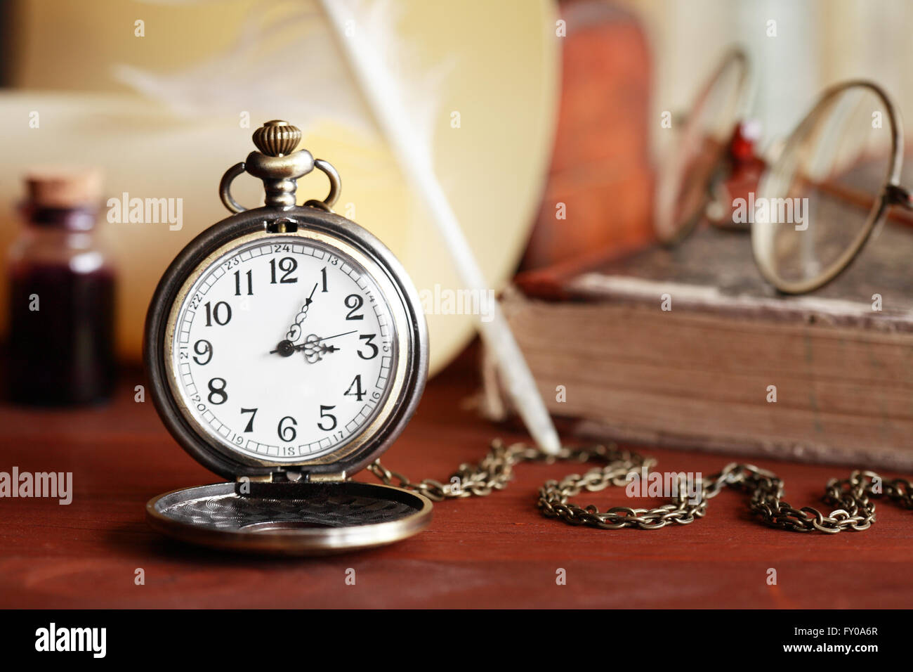 Vintage still life. Pocket watch near scroll and other vintage things ...