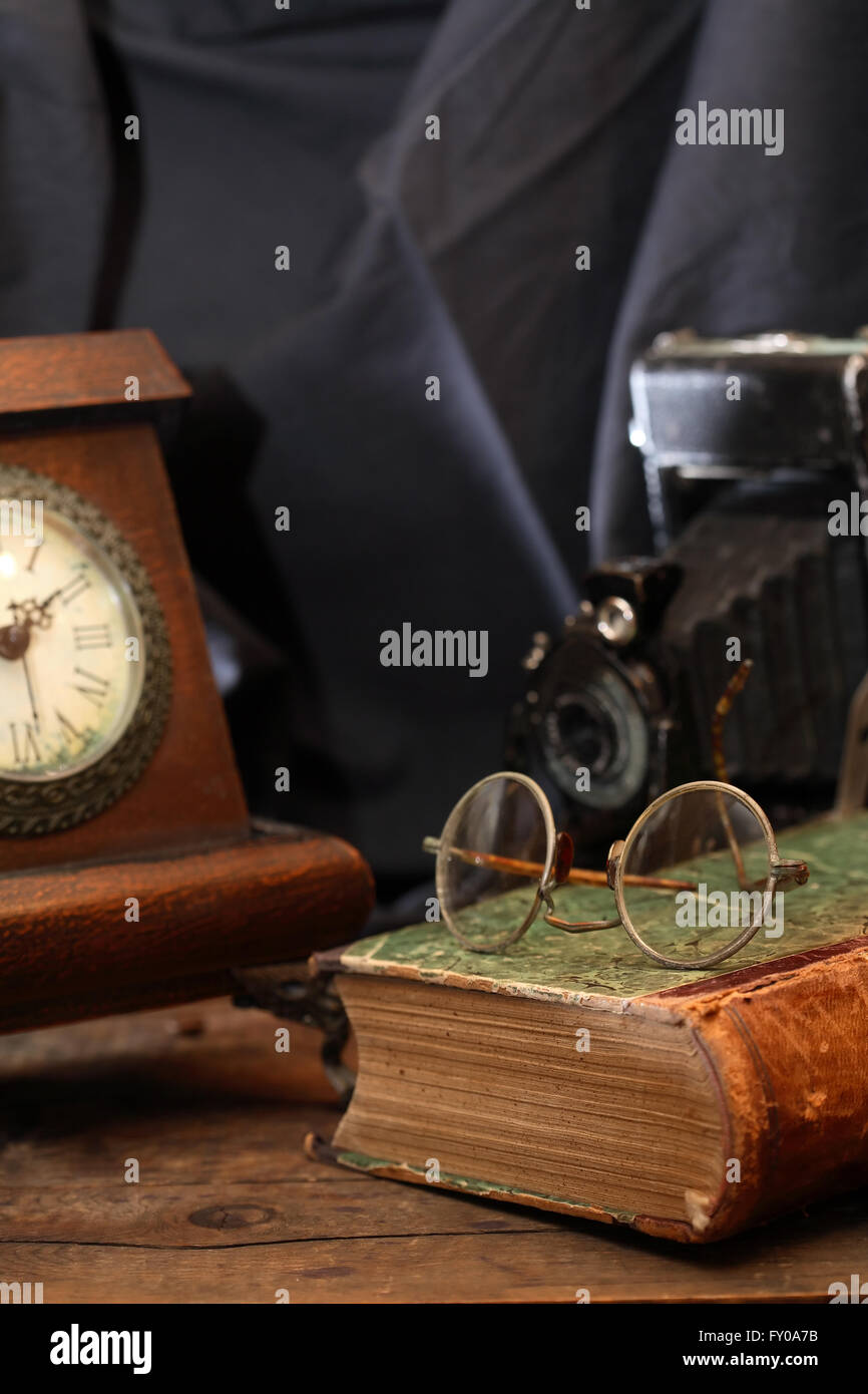 Vintage still life with various old things on dark cloth background ...