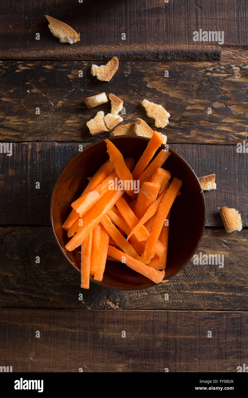 Fresh cut carrot on wooden background Stock Photo - Alamy