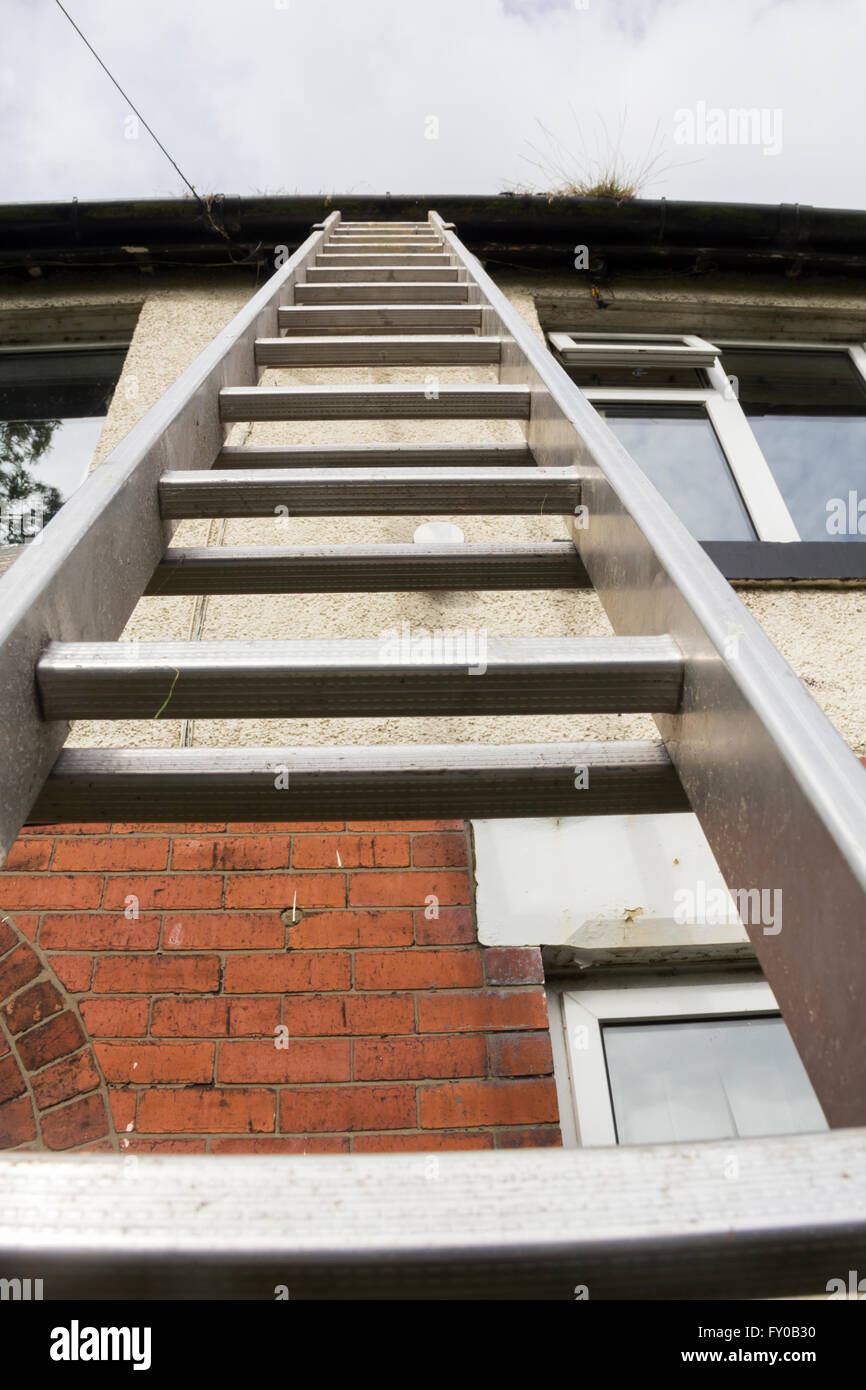 Empty ladder leaning on the front of a 1930s semi-detached house in ...