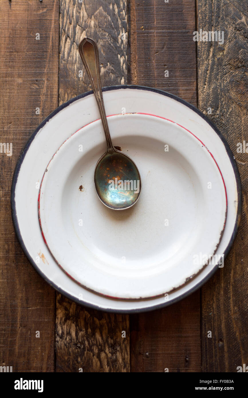 empty soup bowl with spoon on old wooden background Stock Photo - Alamy