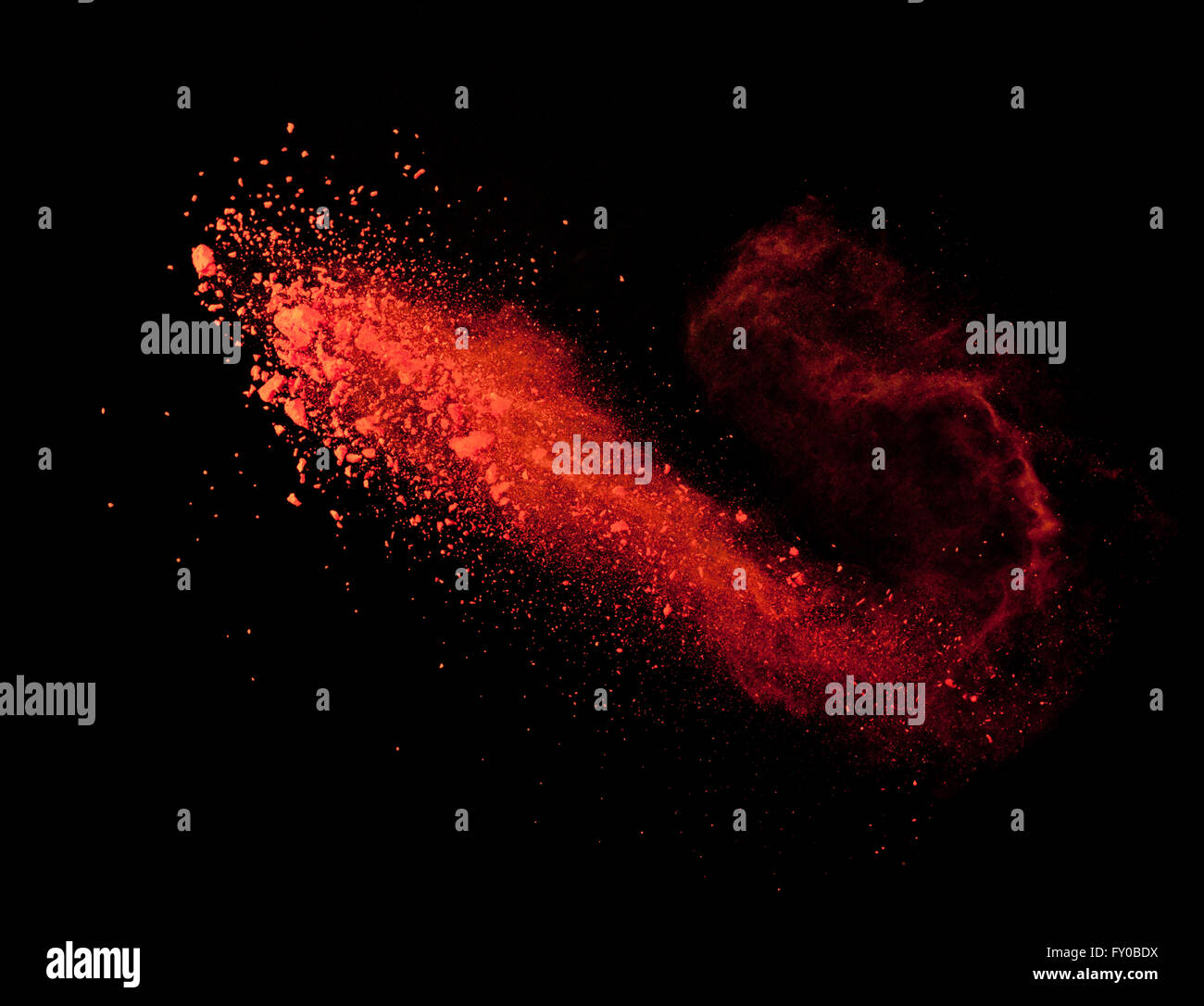 Explosion of red powder on black background Stock Photo - Alamy