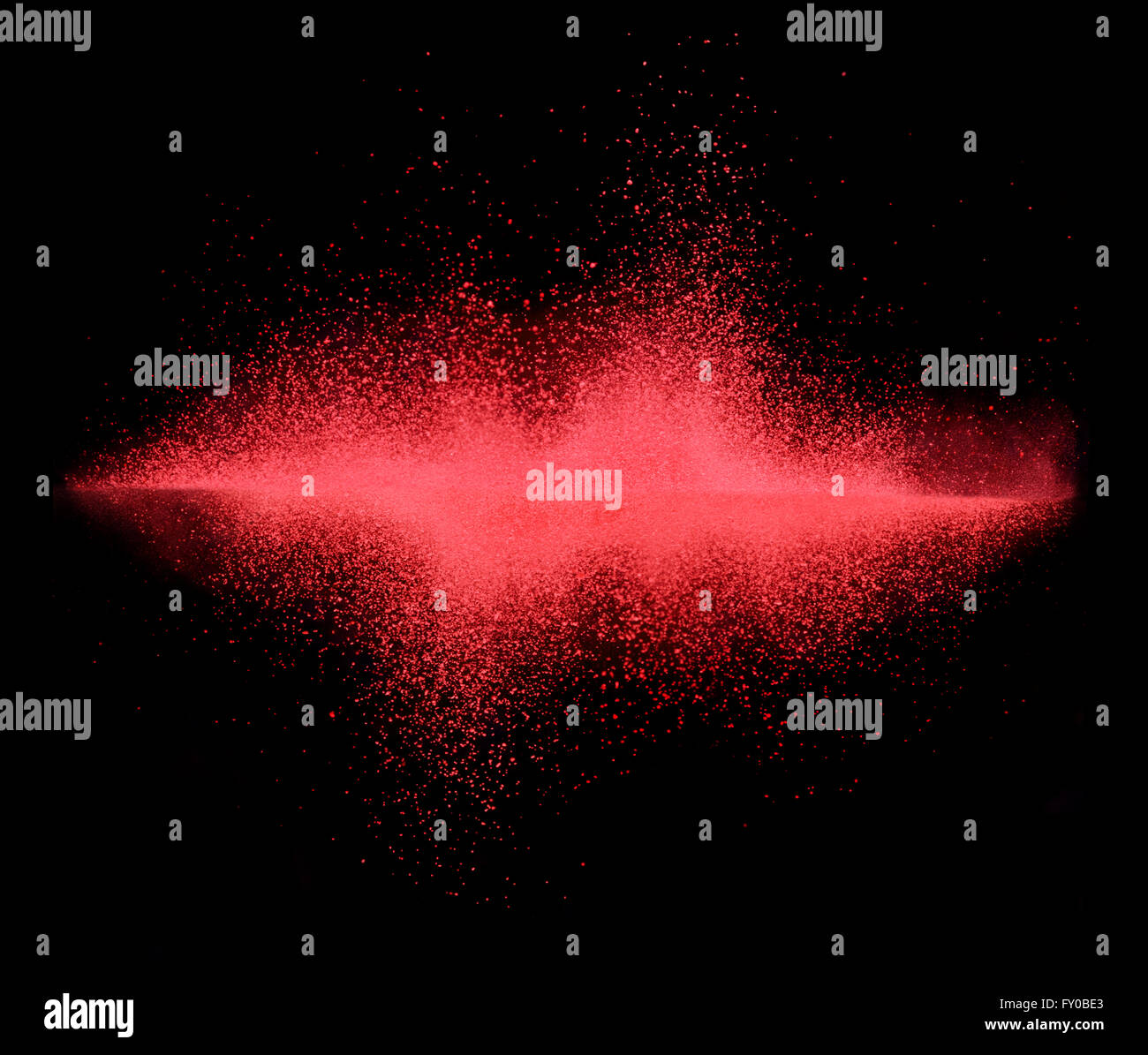Explosion of red powder on black background Stock Photo - Alamy