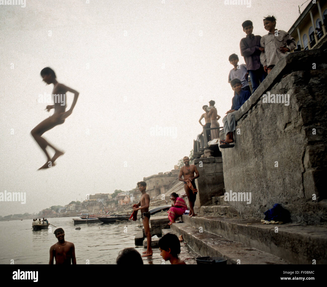 A boy jumps over Ganga (Ganges) river in Varanasi, Uttar Pradesh, India ...