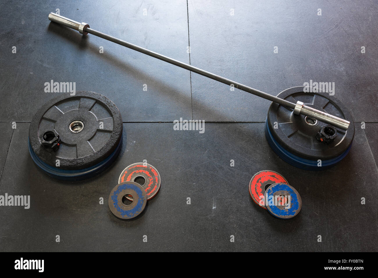 Barbell and weights on a black gym floor, top view Stock Photo - Alamy