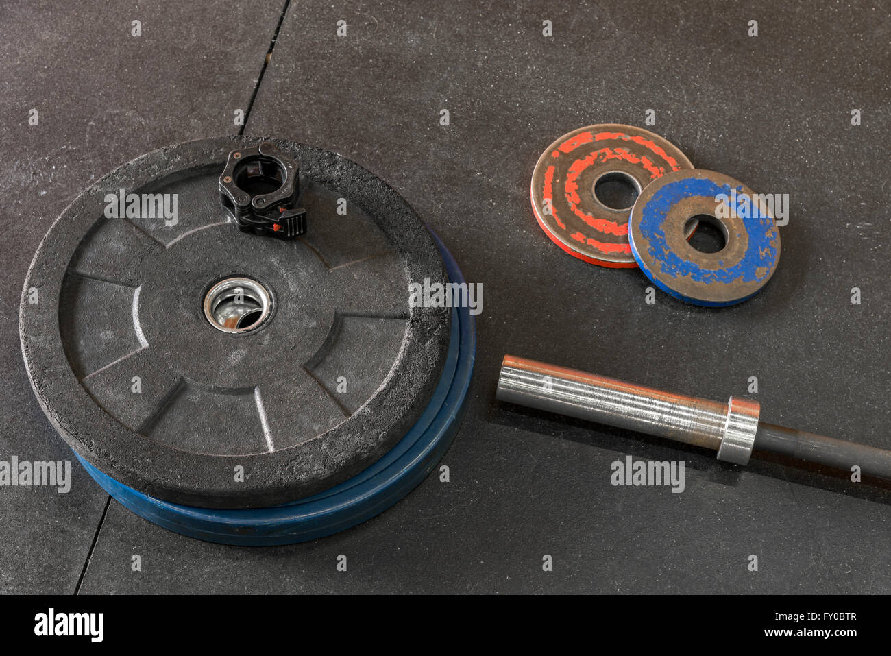 Barbell and weights on a black gym floor, top view Stock Photo - Alamy