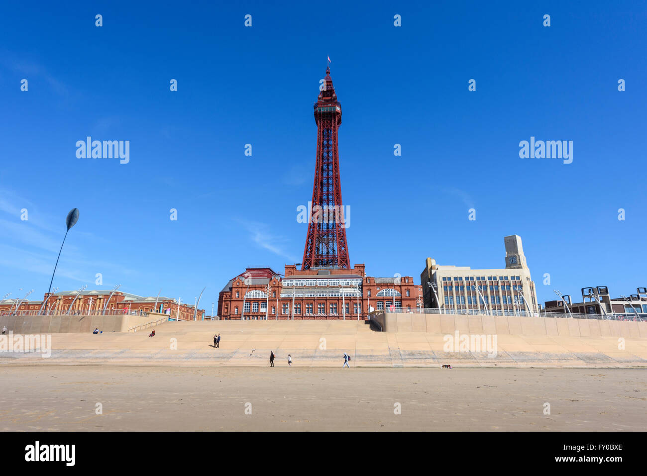 Under a bright blue sky, the view from the sandy beach to the iconic ...
