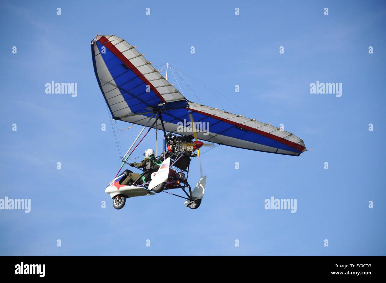 Ultralight trike are flying over the field of the surroundings of the ...