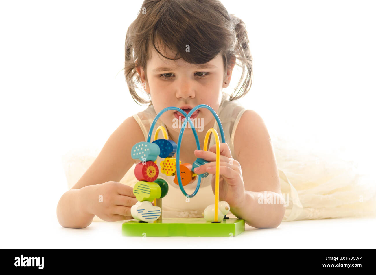 Sweet toddler girl concentrated playing with educational baby wooden ...