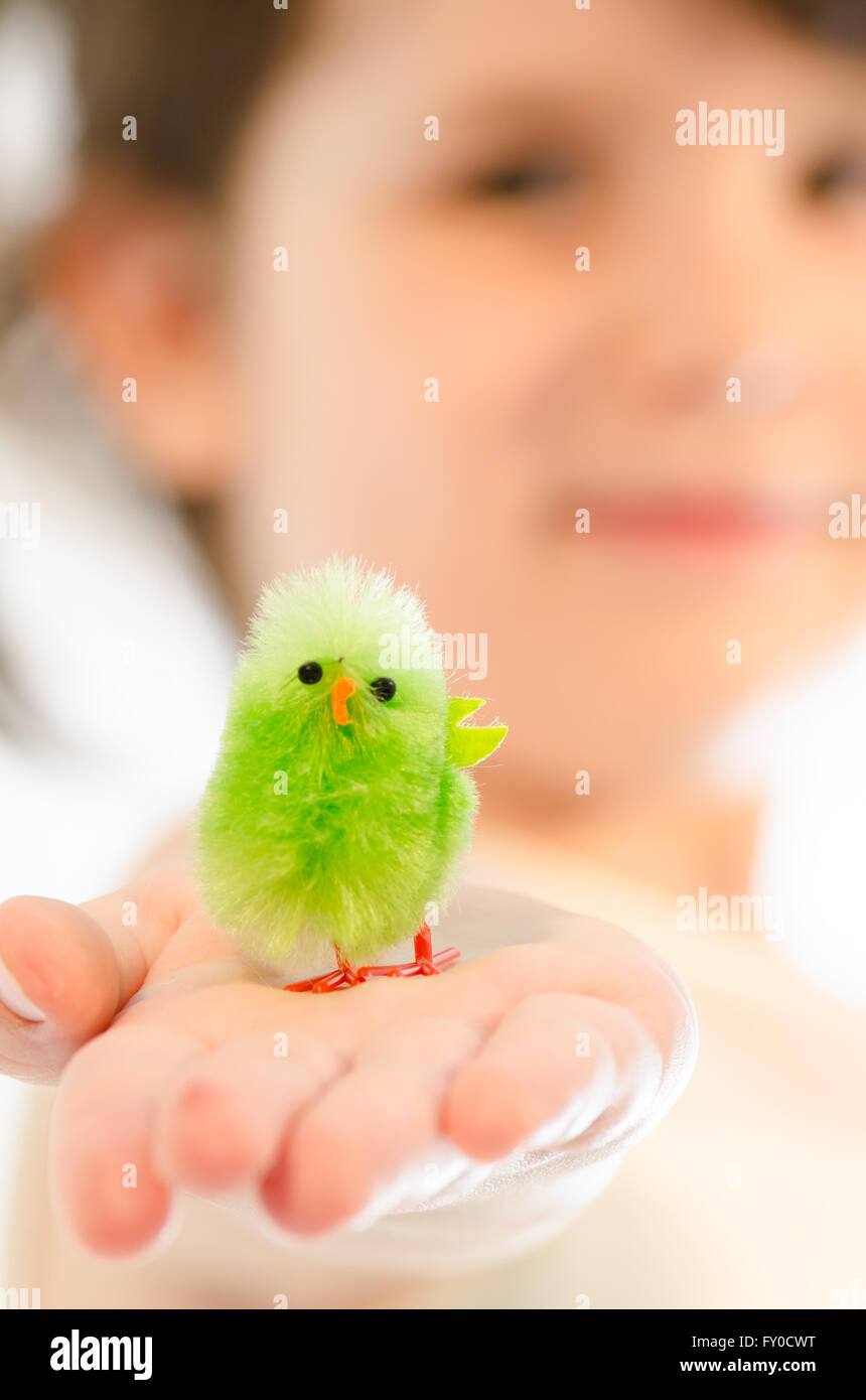 Sweet toddler girl playing with small fluffy pink bird toys isolated on ...