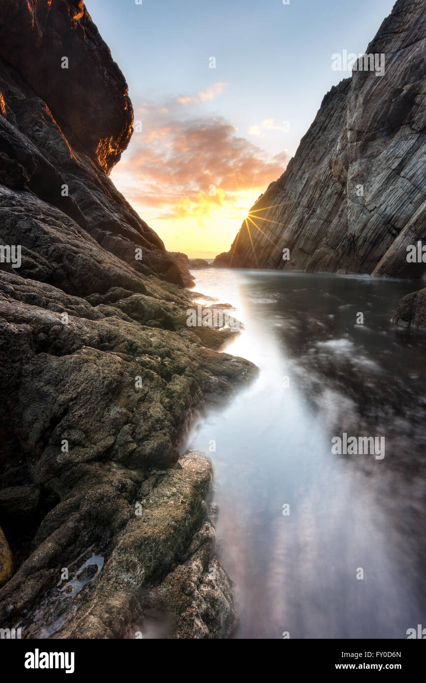 Between the cliff waiting the sunset Stock Photo - Alamy
