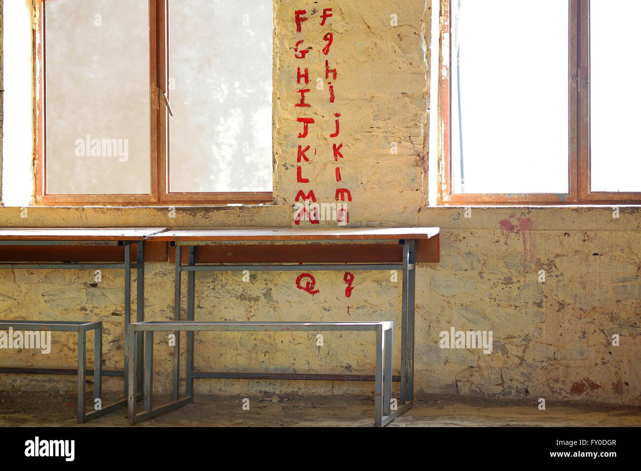 Students. desks under the windows inside a classroom using the walls as ...