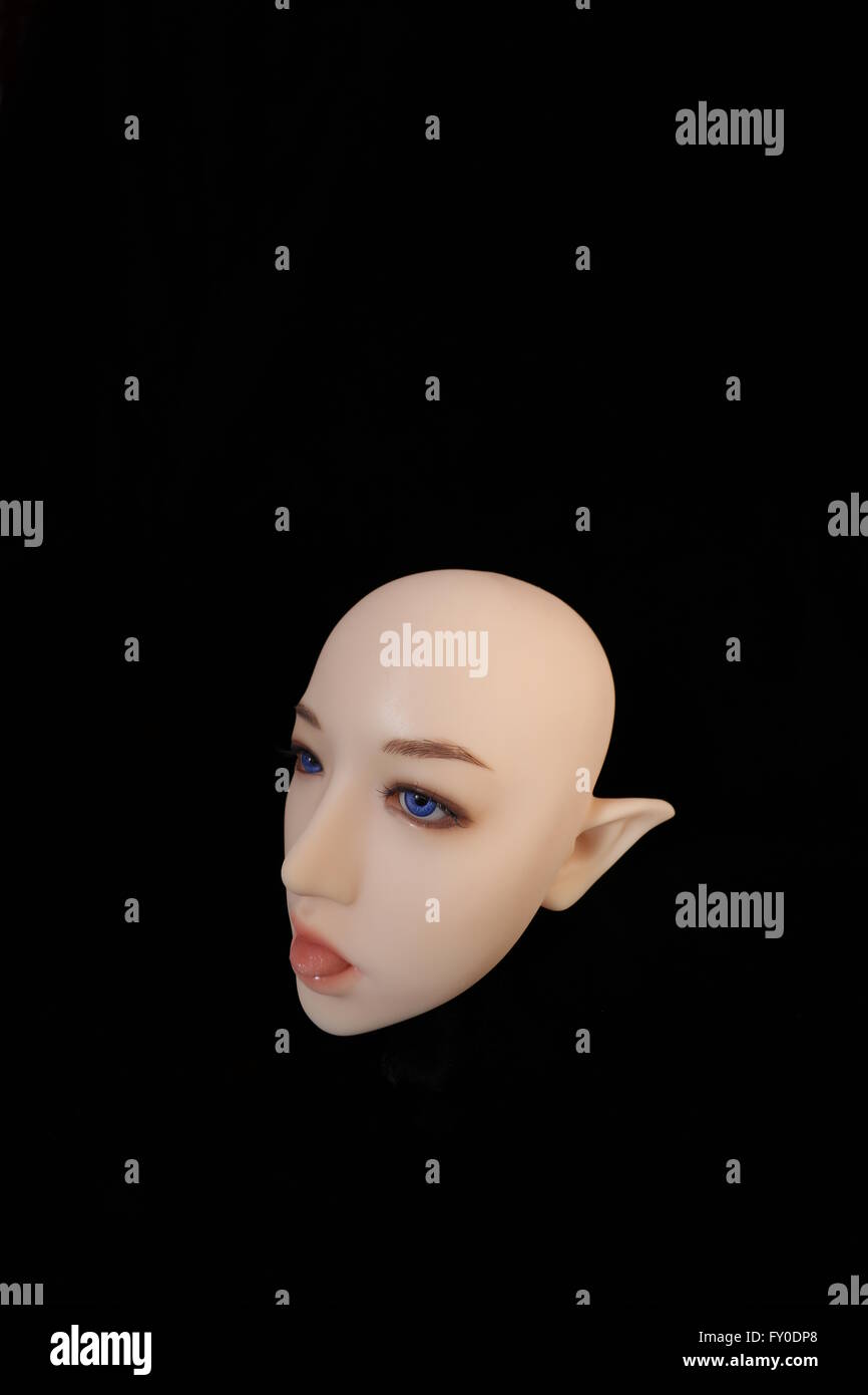 Solitaire silicone elf head with tongue sticking out, black background ...