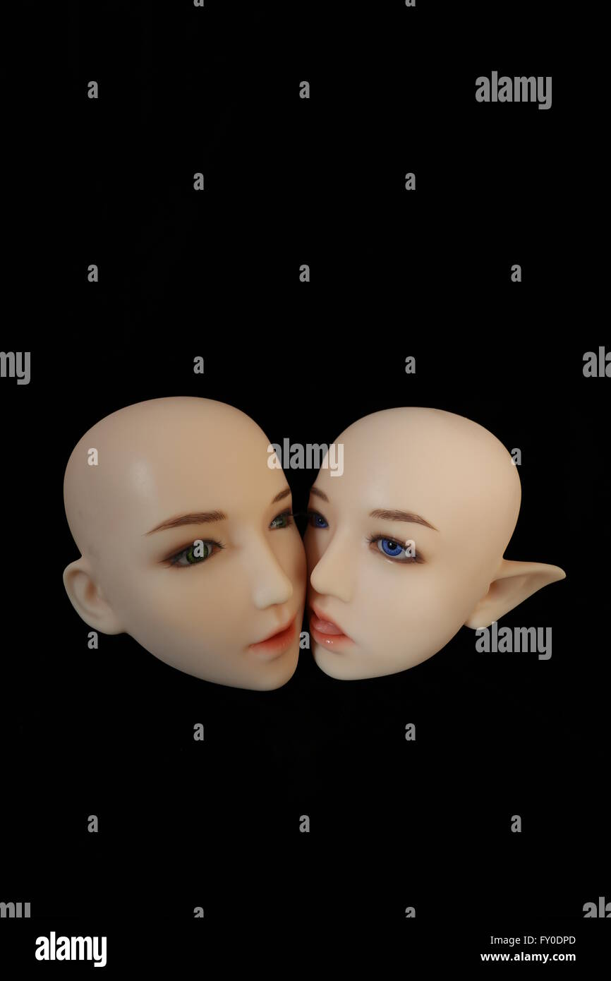 Silicone heads on black background, elf head with tongue sticking out ...