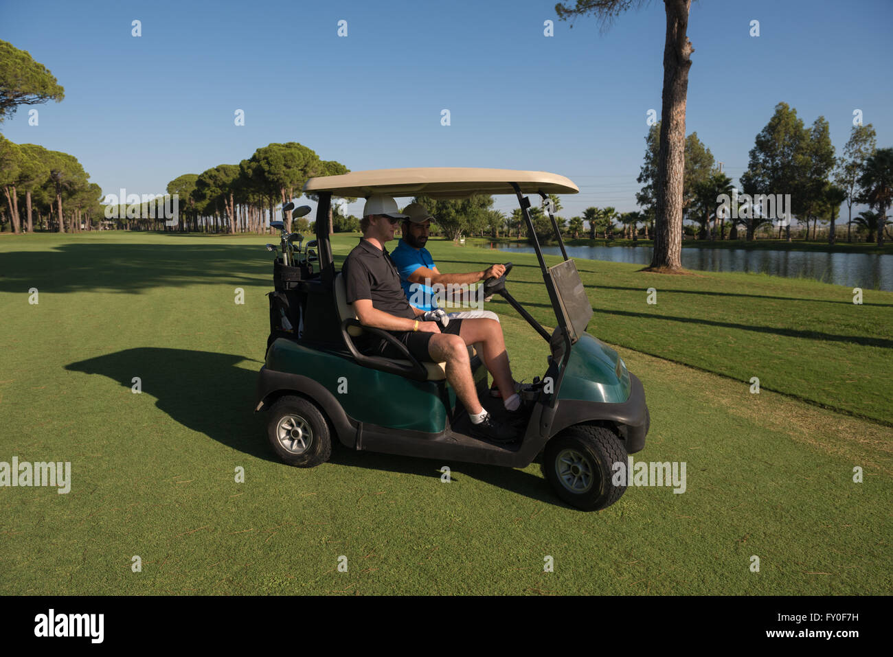 Golf players driving cart hi-res stock photography and images - Alamy
