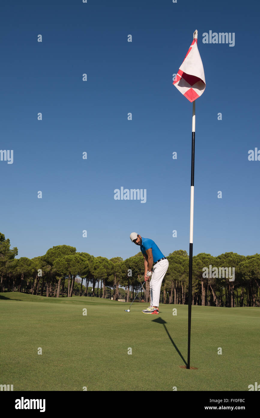 golf player hitting shot with driver on course at beautiful sunny day ...