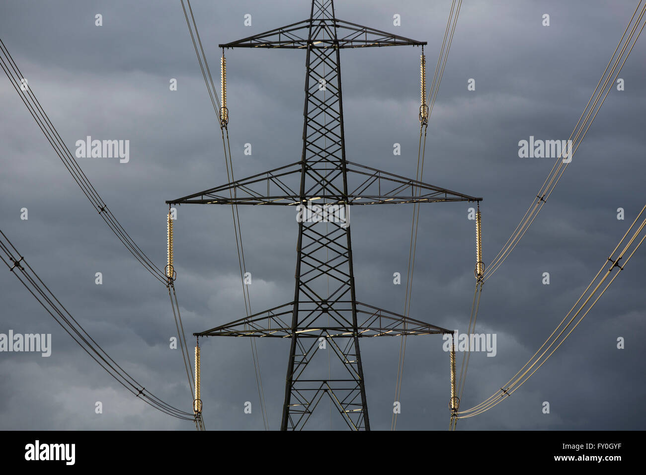 Electrical power lines set against a brooding grey sky Stock Photo - Alamy