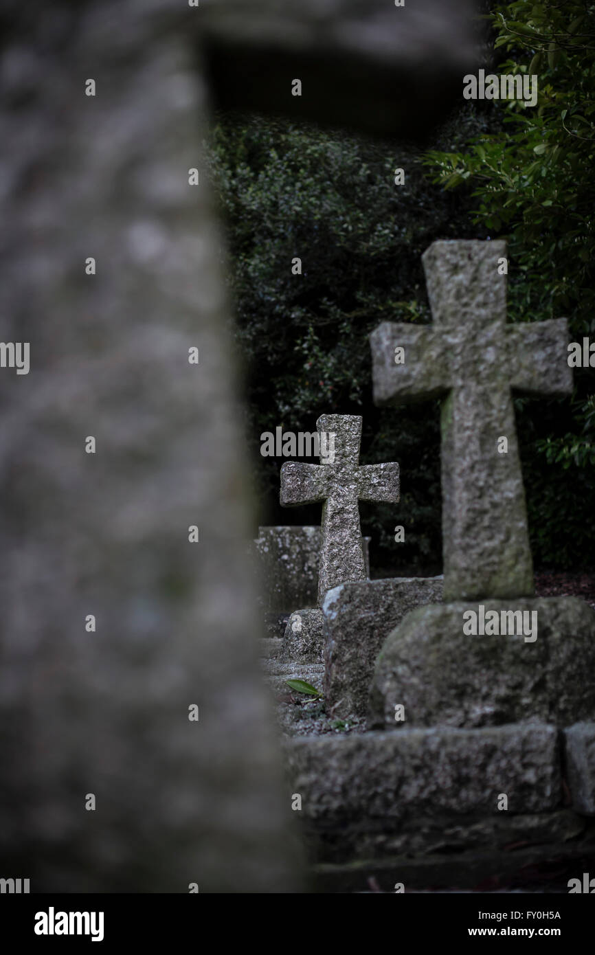A church graveyard with stone memorials, crosses and gravestones Stock ...